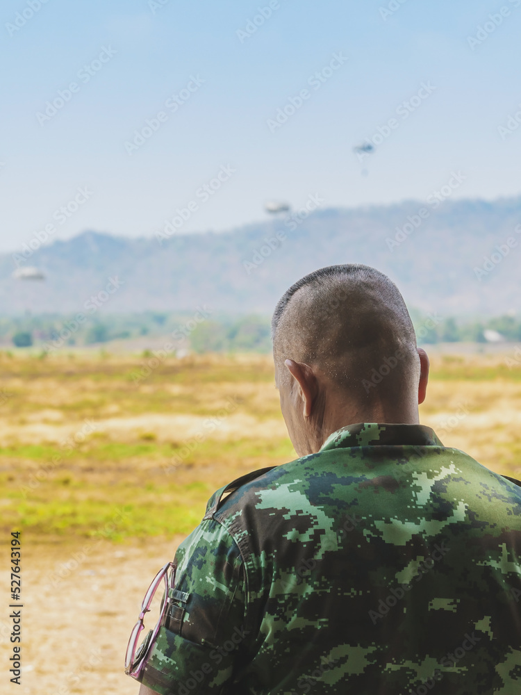 Back view of Asian army soldier stands to explore the landscape in ...