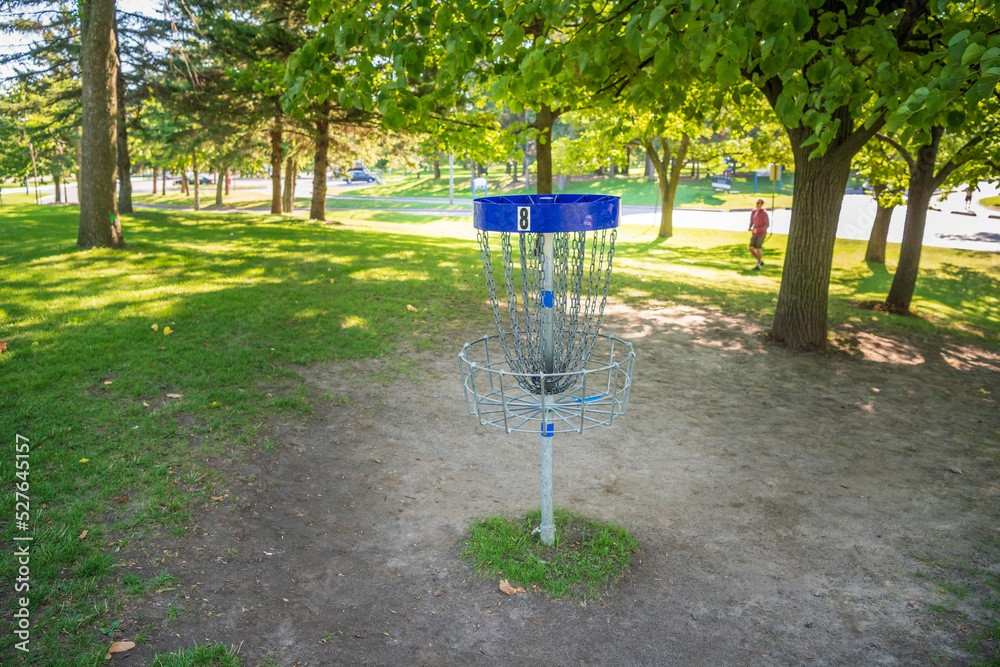 Disc golf, a flying disc sport played using rules like golf, being ...