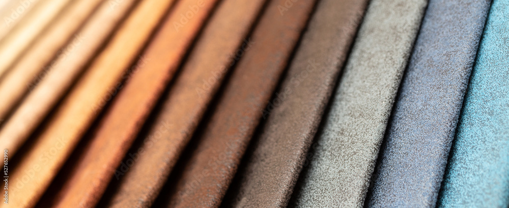 Fabric swatches in different colors are stacked for selection. A ...