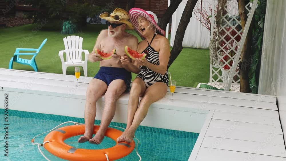 Happy Seniors Making Party In The Swimming Pool During The Summer