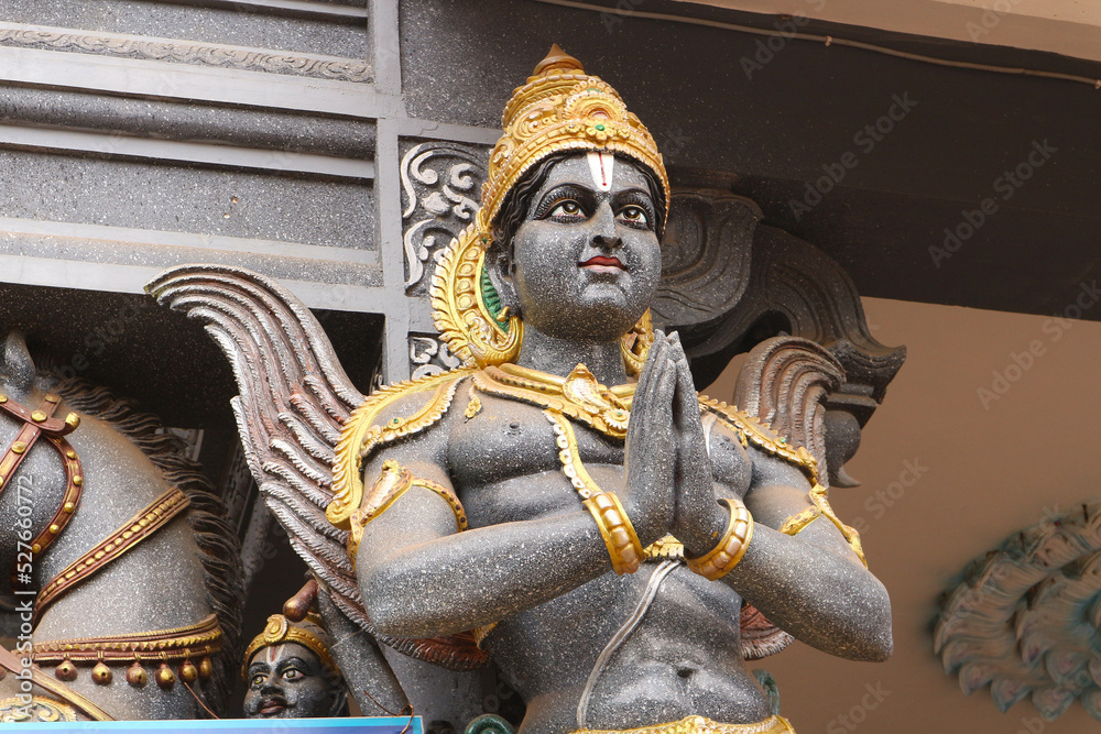 Statue of Garuda in a Hindu temple in India. The bird is the carrier of ...
