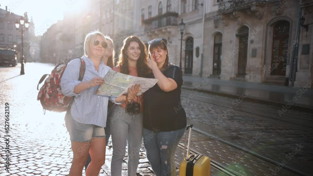 A female tour guide describes the tour and shows tourists a city map ...