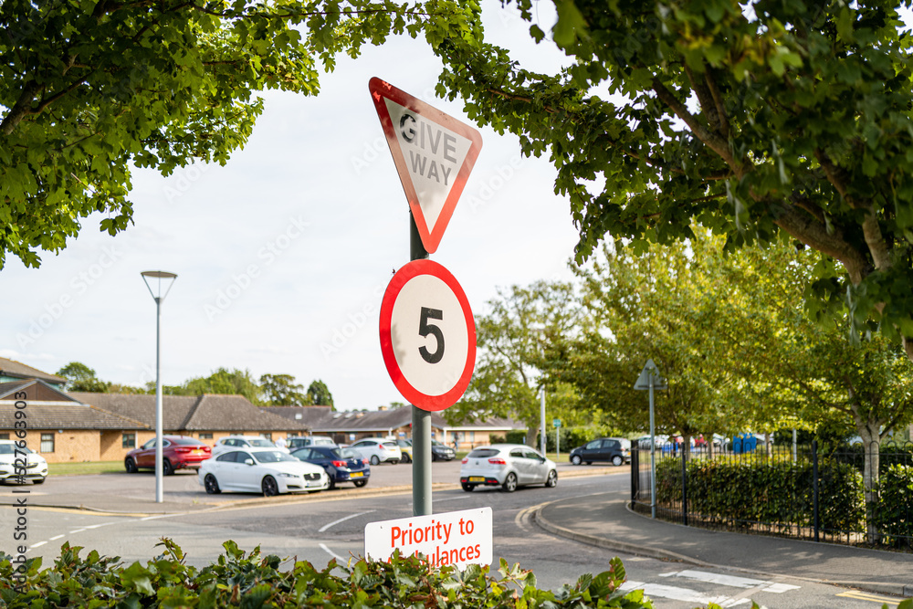 Shallow focus of a Give Way and Speed Limit sign seen within a hospital ...