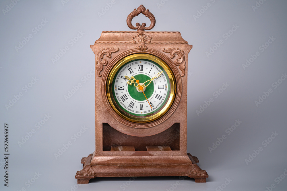 Old plastic table clock with gold stopped hands. Brown vintage watch ...