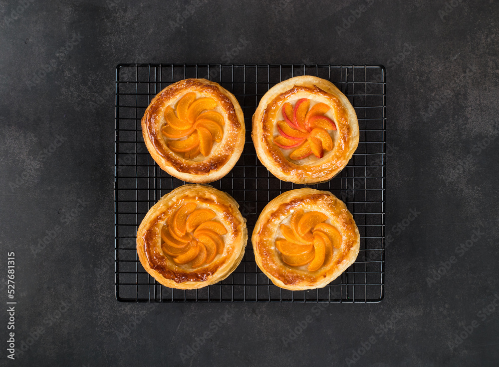 Small open pies made of puff pastry without yeast, with slices of ...