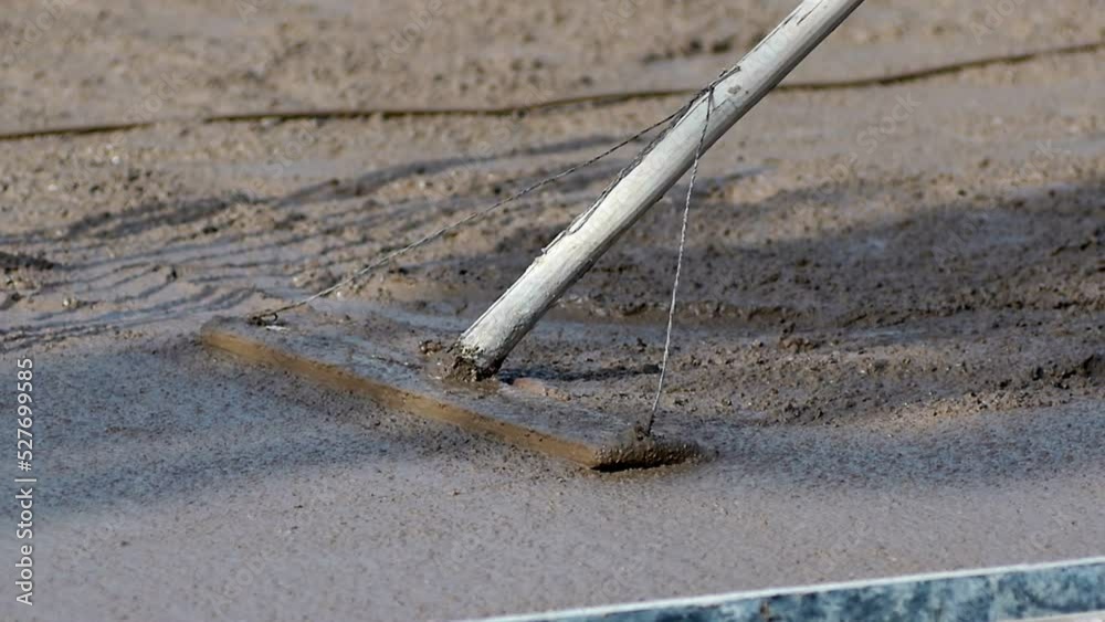 Worker smoothing the concrete surface of basement floor slabs. Concrete ...