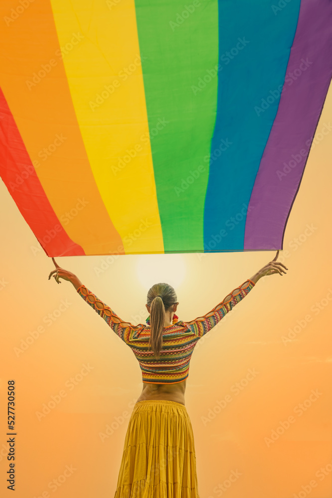 portrait of asian transgender person with rainbow pride flag to ...
