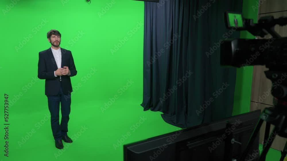 Backstage, news anchor at work, man reporter looks into the camera and ...