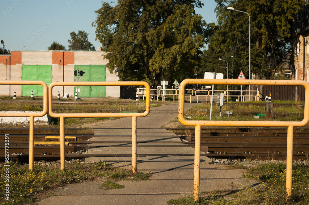 pedestrian crossing over the railway tracks, in the photo there are ...