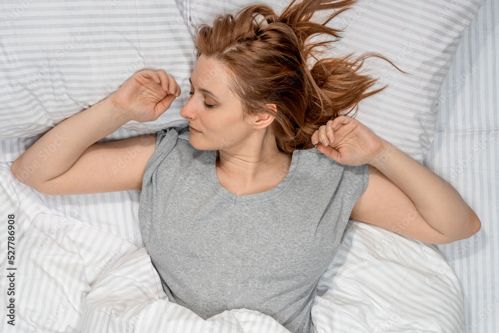 Woman sleeping in bed at home. Deep restful sleep. Lady with long brown ...