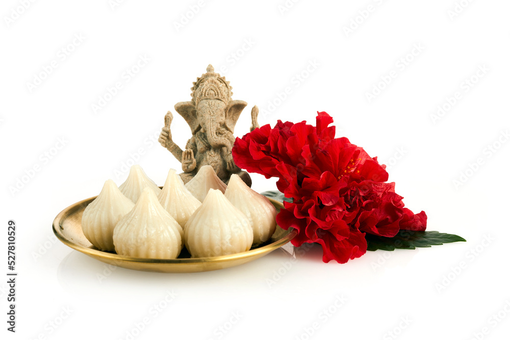 Idol of lord Ganesha with Modak Sweet Dish and flower. Ganesh chaturthi ...