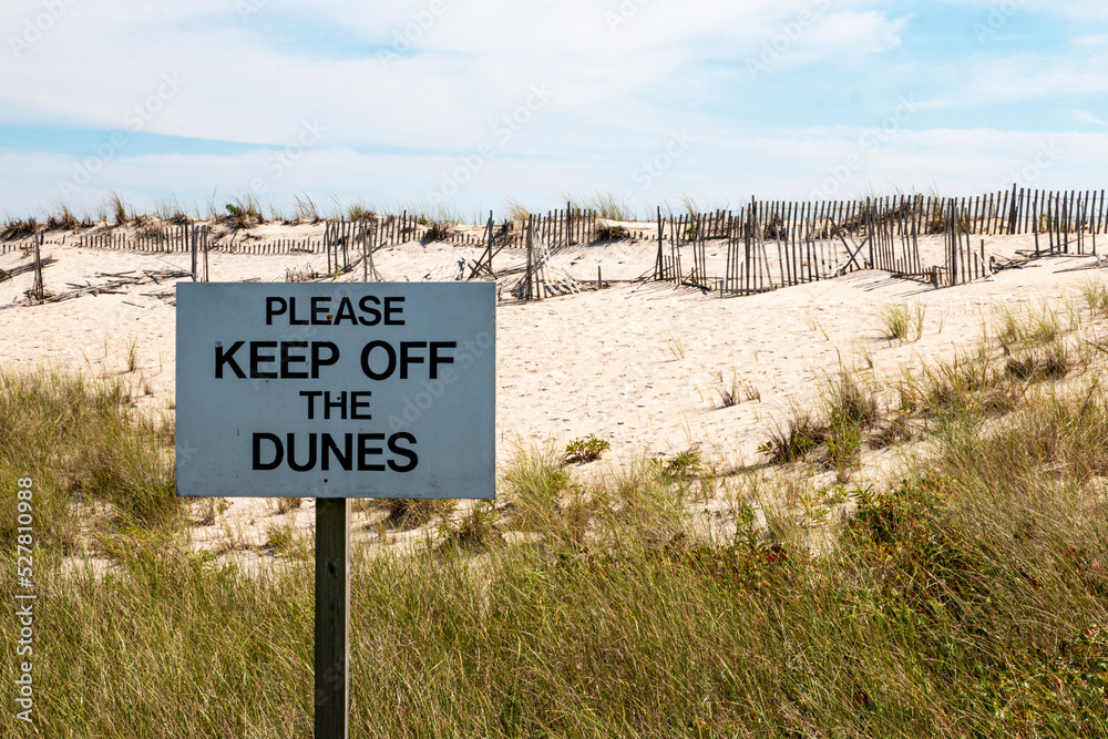 Please keep off the dunes sign with broken snow fences in the backgound ...
