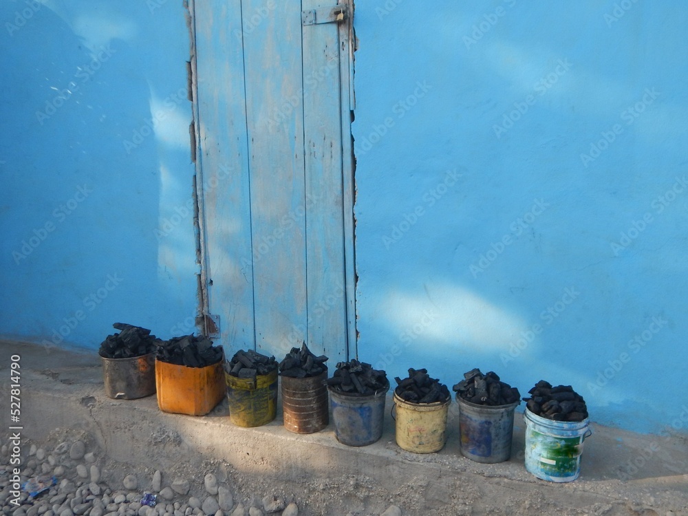 coal in buckets for cooking in the community of Anse a Pitres in Haiti ...