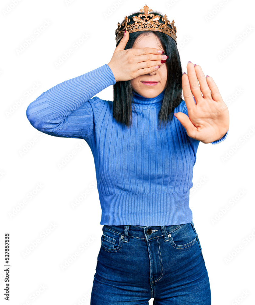Young brunette woman with blue eyes wearing princess crown covering ...