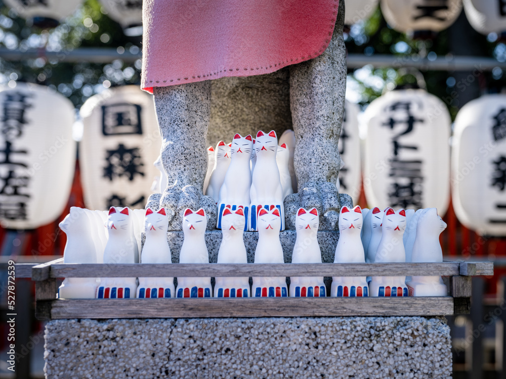 collection of statues of cute inari foxes at a japanese shinto shrine ...
