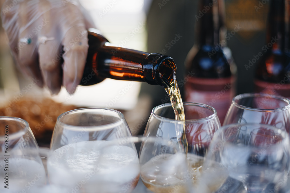 Mid section of bartender pouring beer in a glass at bar counter Stock ...