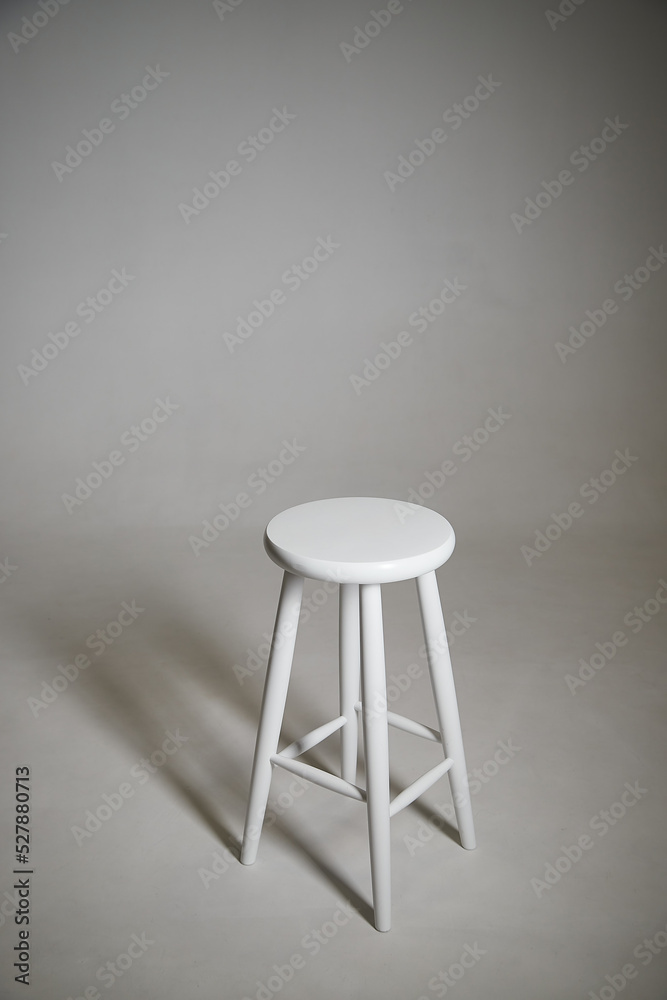 White stool with shadow on white background. Location in studio with ...