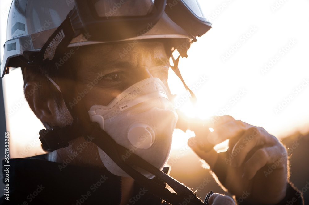 Firefighter getting dressed to start work disinfecting a building Stock ...