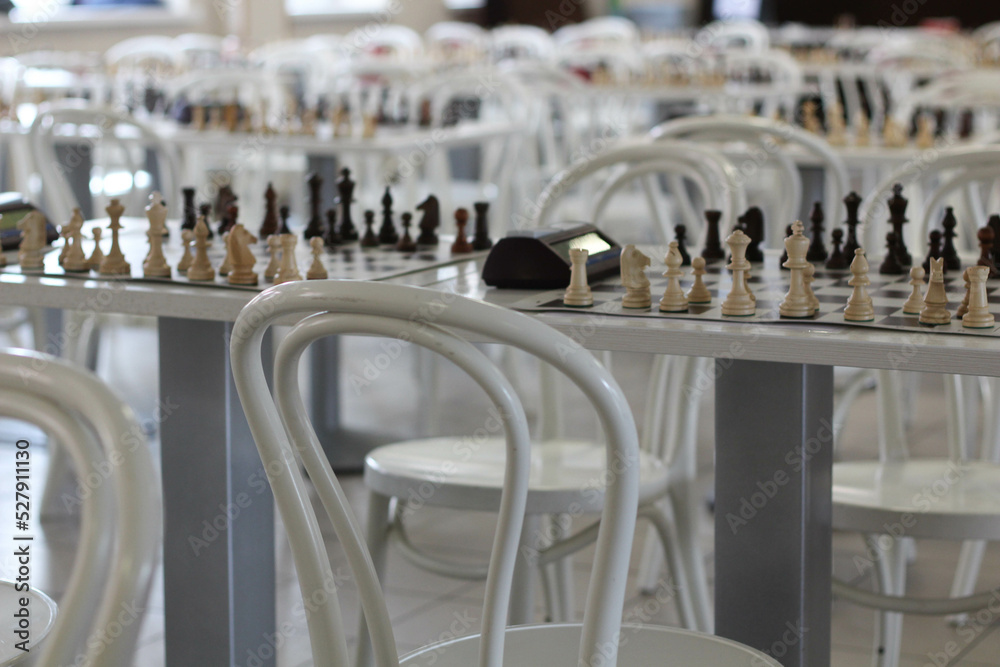 A chess table. Part of interior with white chairs and table. Concept ...