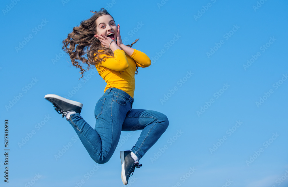 surprised teen girl jump high on sky background Stock Photo | Adobe Stock