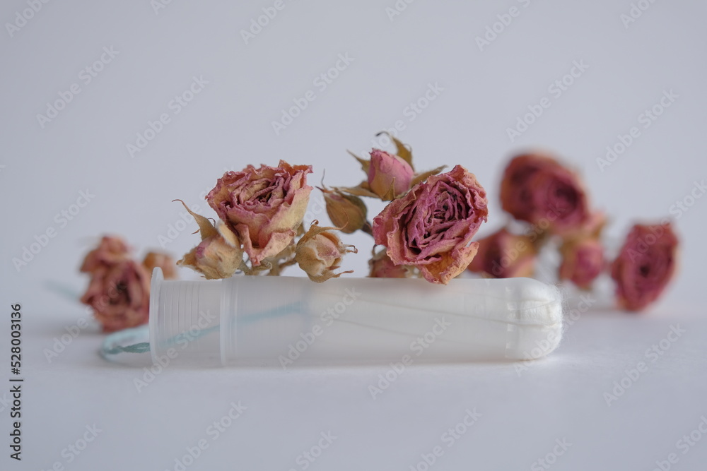 menopause concept. dried red rose lies on a woman tampon. dried rose ...