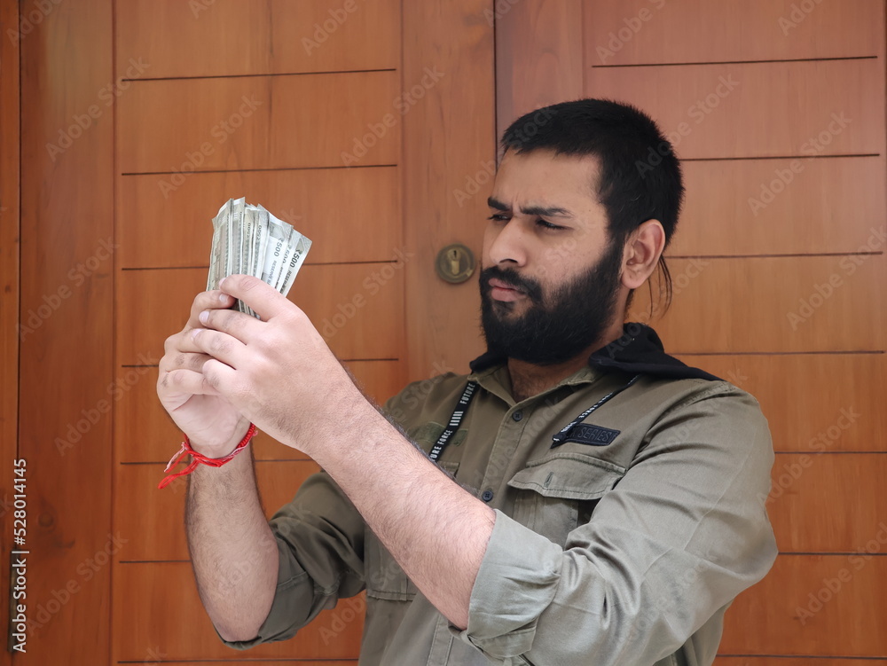 Angry man finding Fake Indian rupees. Concept shot of receiving fake ...