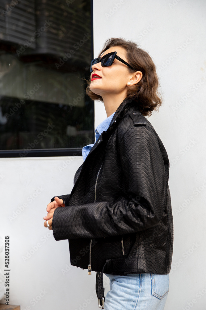 Fashion pretty woman model wearing a black leather python jacket rock ...