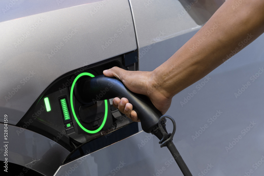 Stockfoto EV Car. driver hand fill up with power cable supply plugged ...