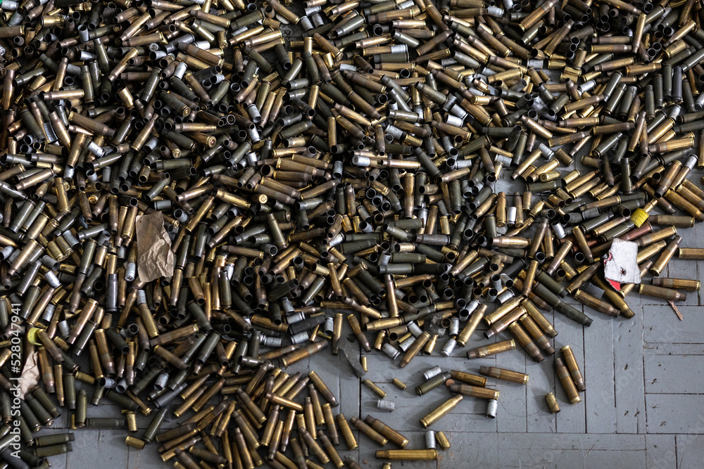 on the floor in the shooting range there are casings from fired ...