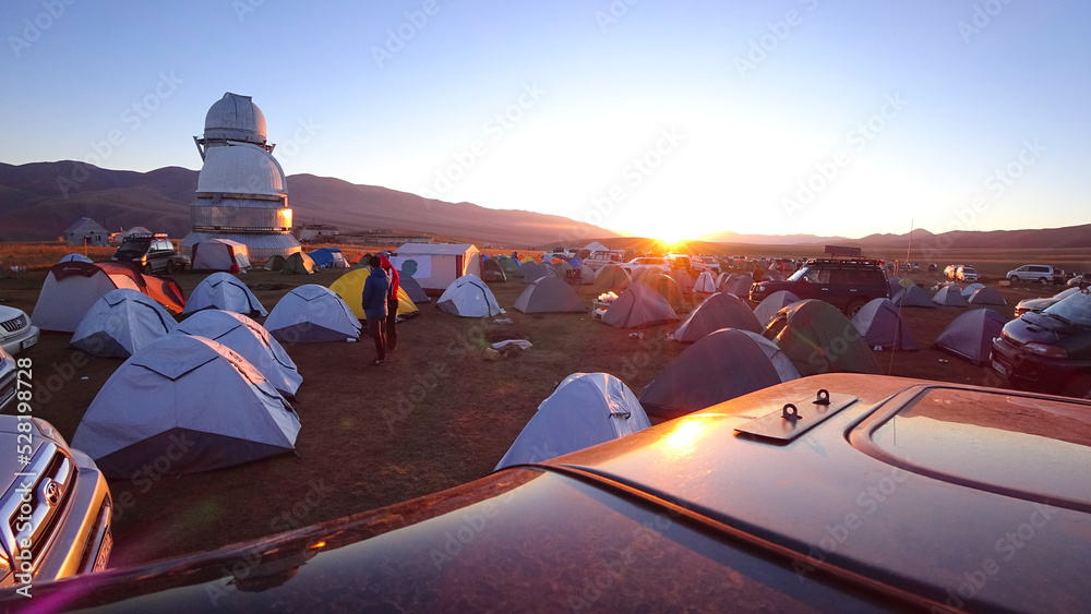 Sunrise over the camp near the Assi Observatory. The sun comes out from ...