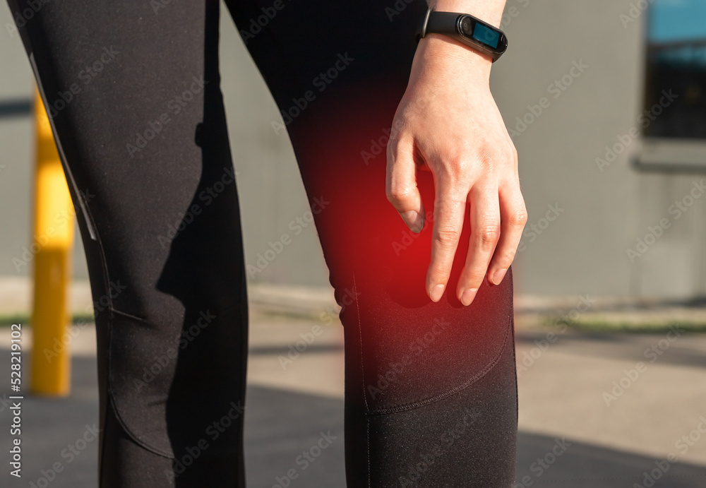 Knee pain, sports trauma concept. Woman holding painful kneecap with ...