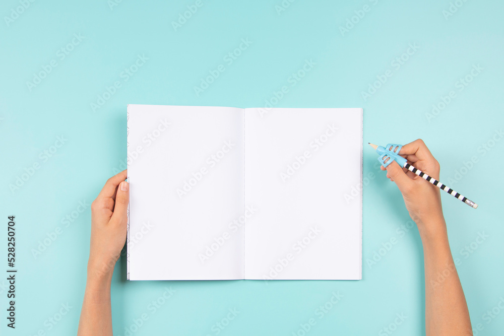 Kid hands using pencil with silicone three finger pen holder. Hand ...