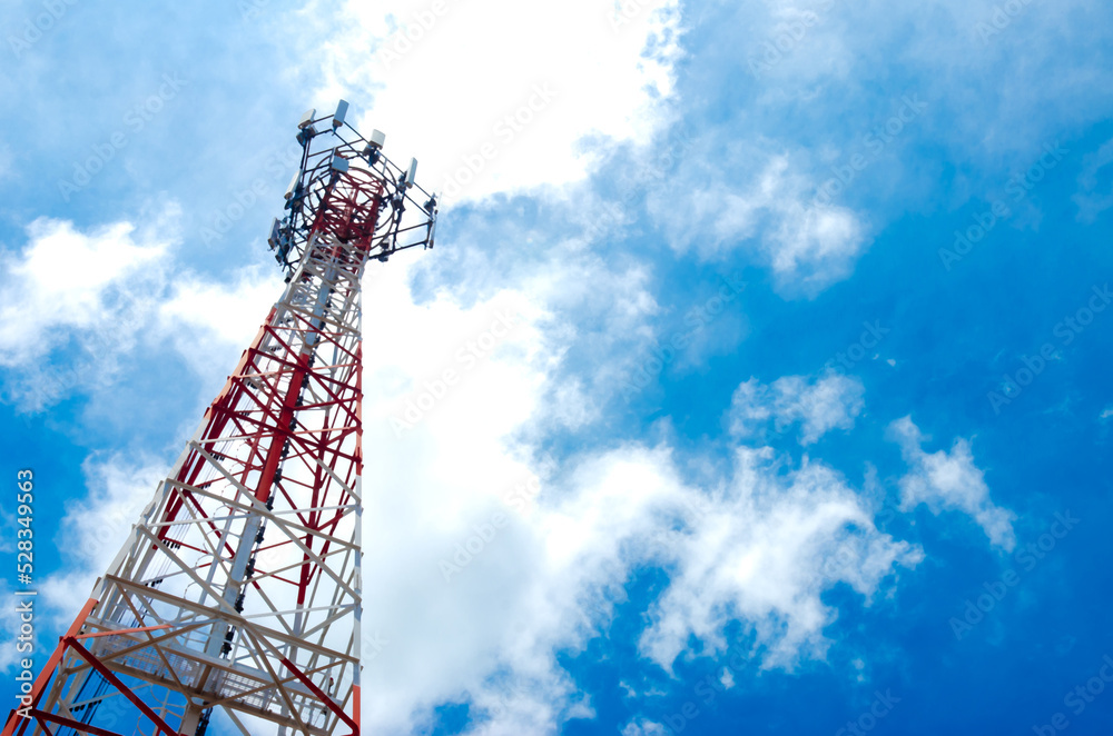 Telecommunication tower for 5G network, on blue sky background ...