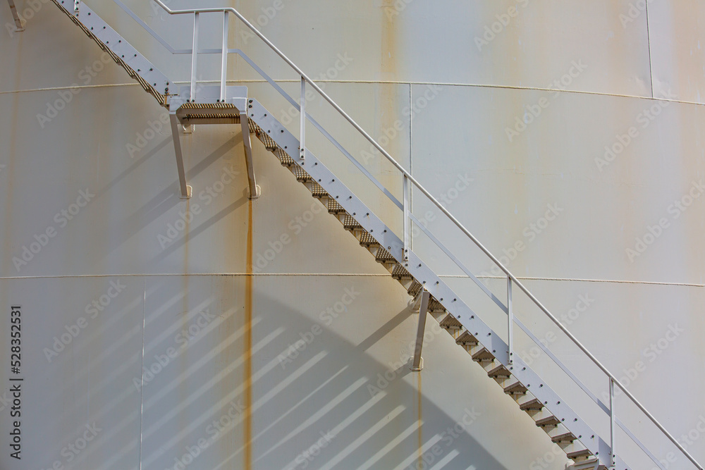Detail of white tanks in tank farm with iron staircase Stock Photo ...