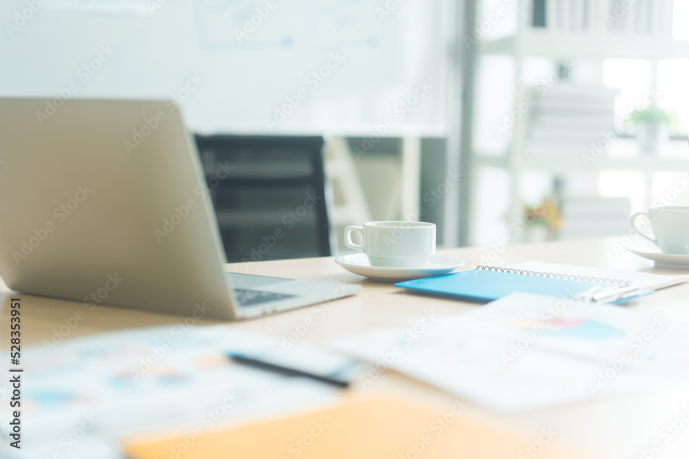 Coffee cup place on work table with laptop computer indoors office with ...