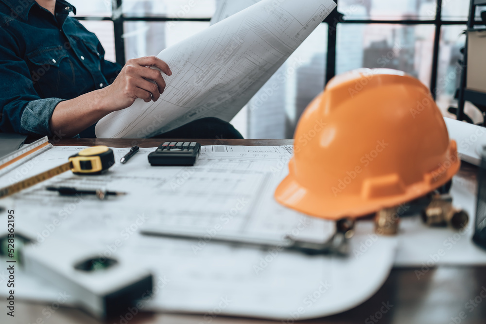 Engineering working with drawings inspection on the office desk and ...
