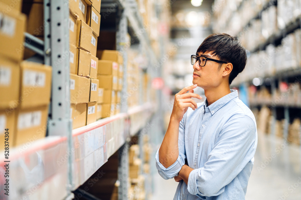 Portrait of smiling asian engineer man order details checking goods and ...