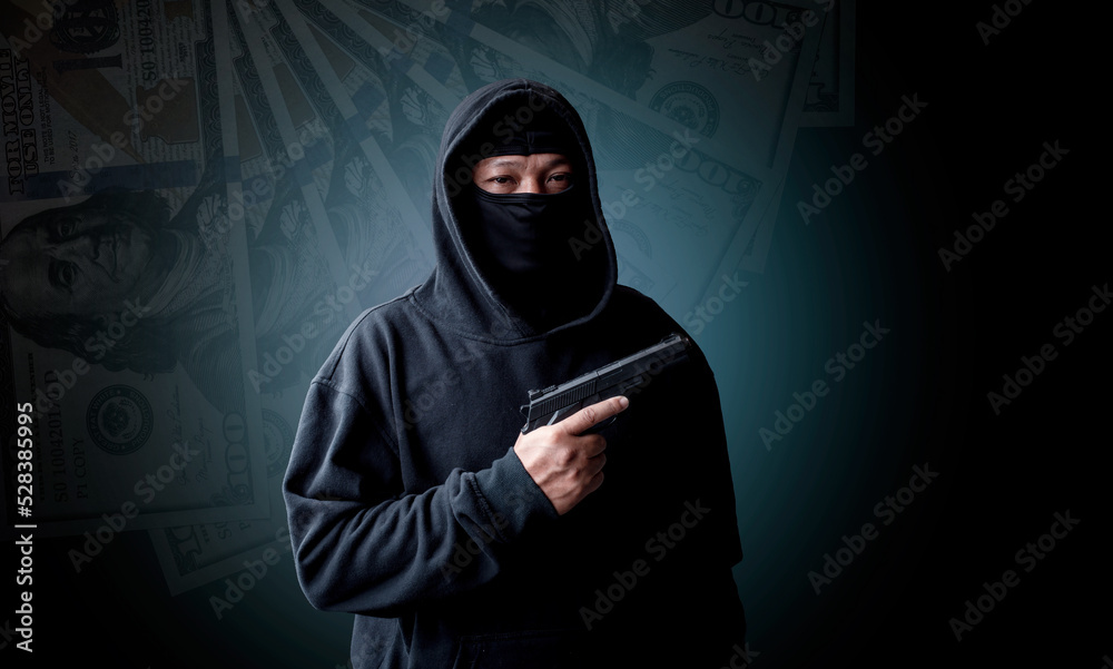 Double exposure thief or bandit man wearing black mask and holding gun ...