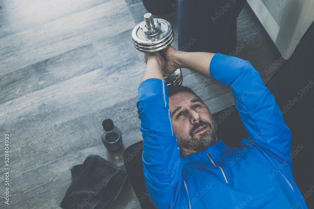 Determined sporty young man working out and trains at home. Fit male ...