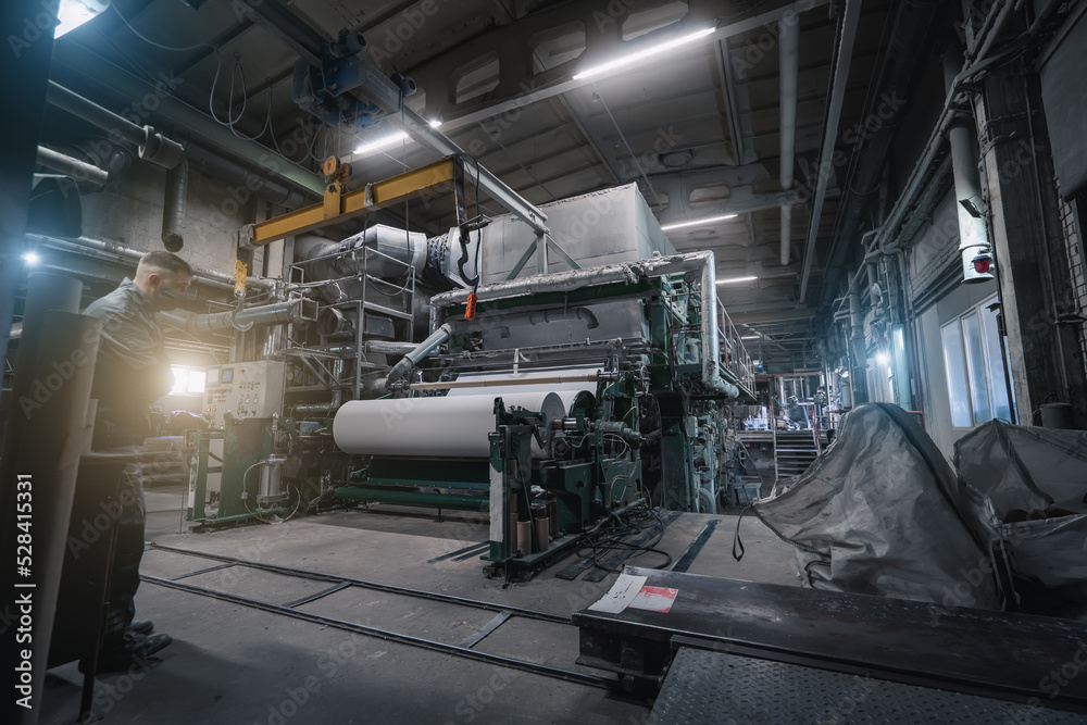 Paper production machine in wastepaper recycling factory. Paper and ...