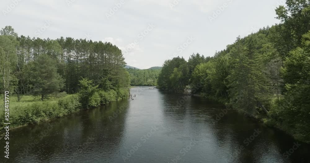 Drone flying over a beautiful river in the summer then moving up and ...