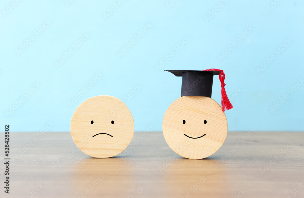 A smiling face with a graduation cap, in front of a sad face. Concept ...