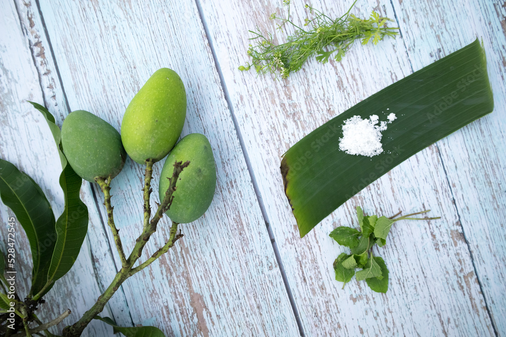 Some raw mango or kaccha aam with some ingrediants like chilli, salt ...