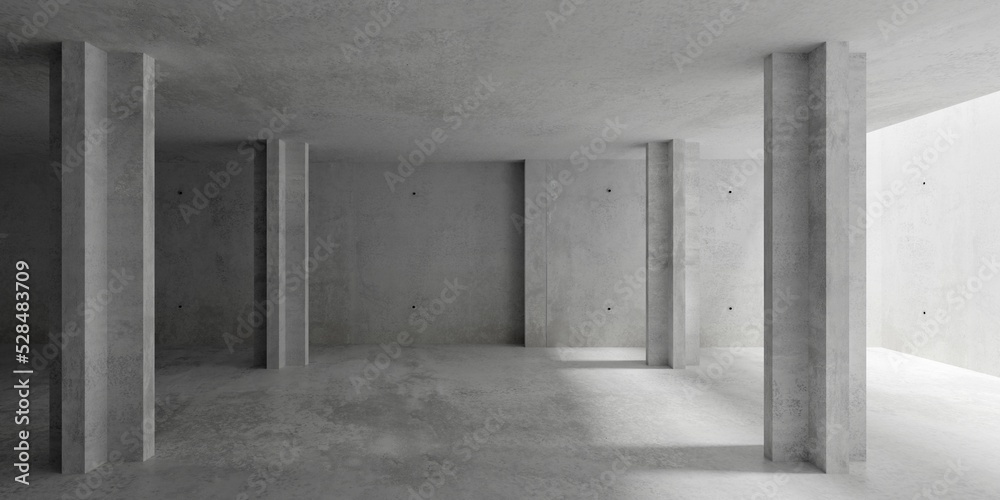 Abstract large, empty, modern concrete room with sunlight from ceiling ...