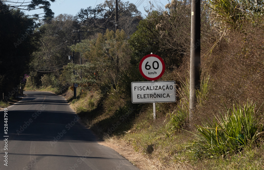 Paved road in the countryside during the morning and speed limit sign ...