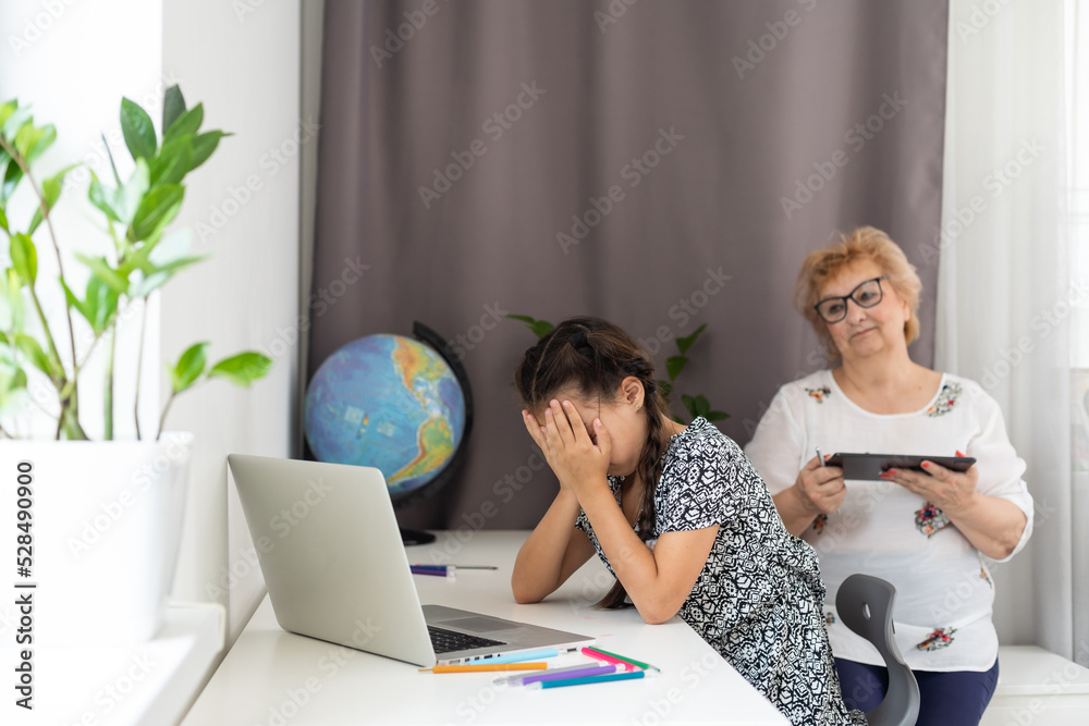 little sad girl and grandmother argue at home Stock Photo | Adobe Stock