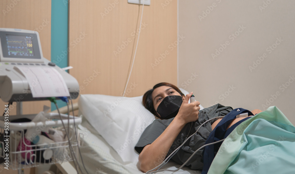 Pregnant people use Fetal Monitor on hospital for uterine contraction ...