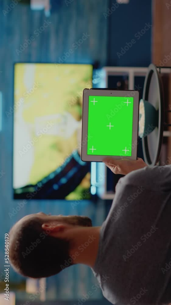 Person using modern tablet horizontally for green screen display in ...