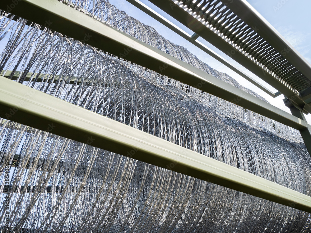 Barbed wire technology. Temporary steel fence with spikes. Fragment of ...