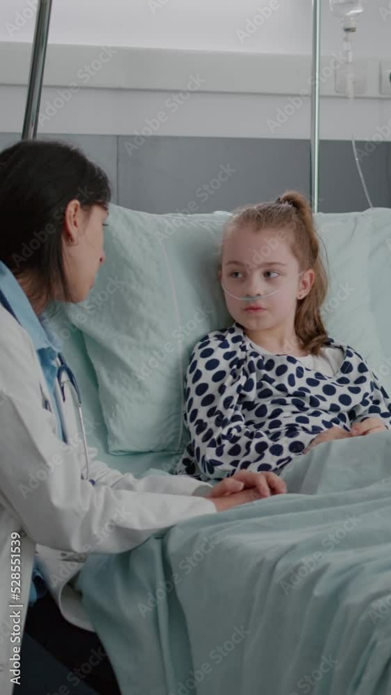 vertical video: Pediatric woman doctor interacting with sick patient ...